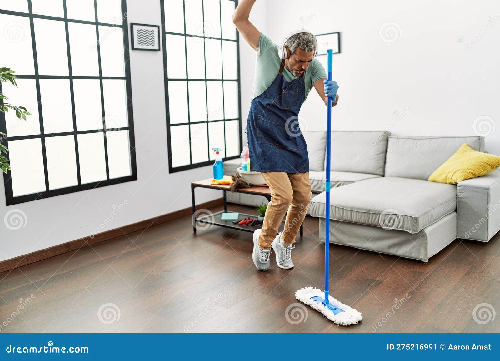 Middle Age Grey-haired Man Singing Song Using Mop As a Microphone at ...