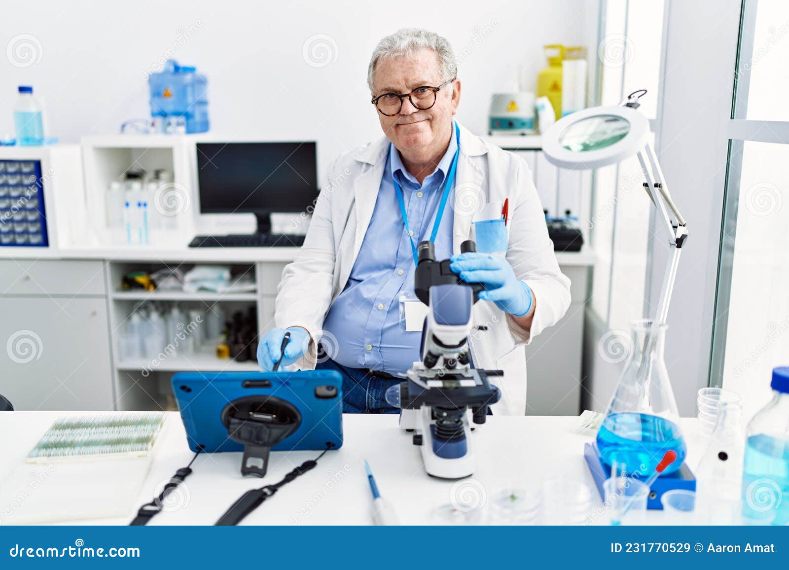 Middle Age Grey-haired Man Wearing Scientist Uniform Using Microscope ...