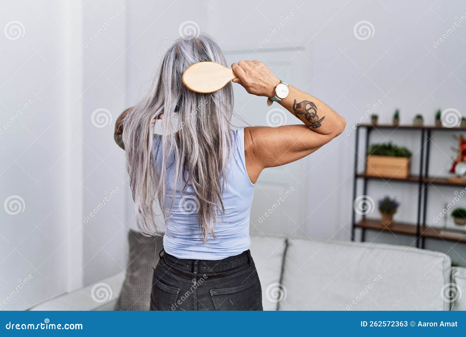 Middle Age Grey-haired Woman on Back View Combing Hair Standing at Home ...