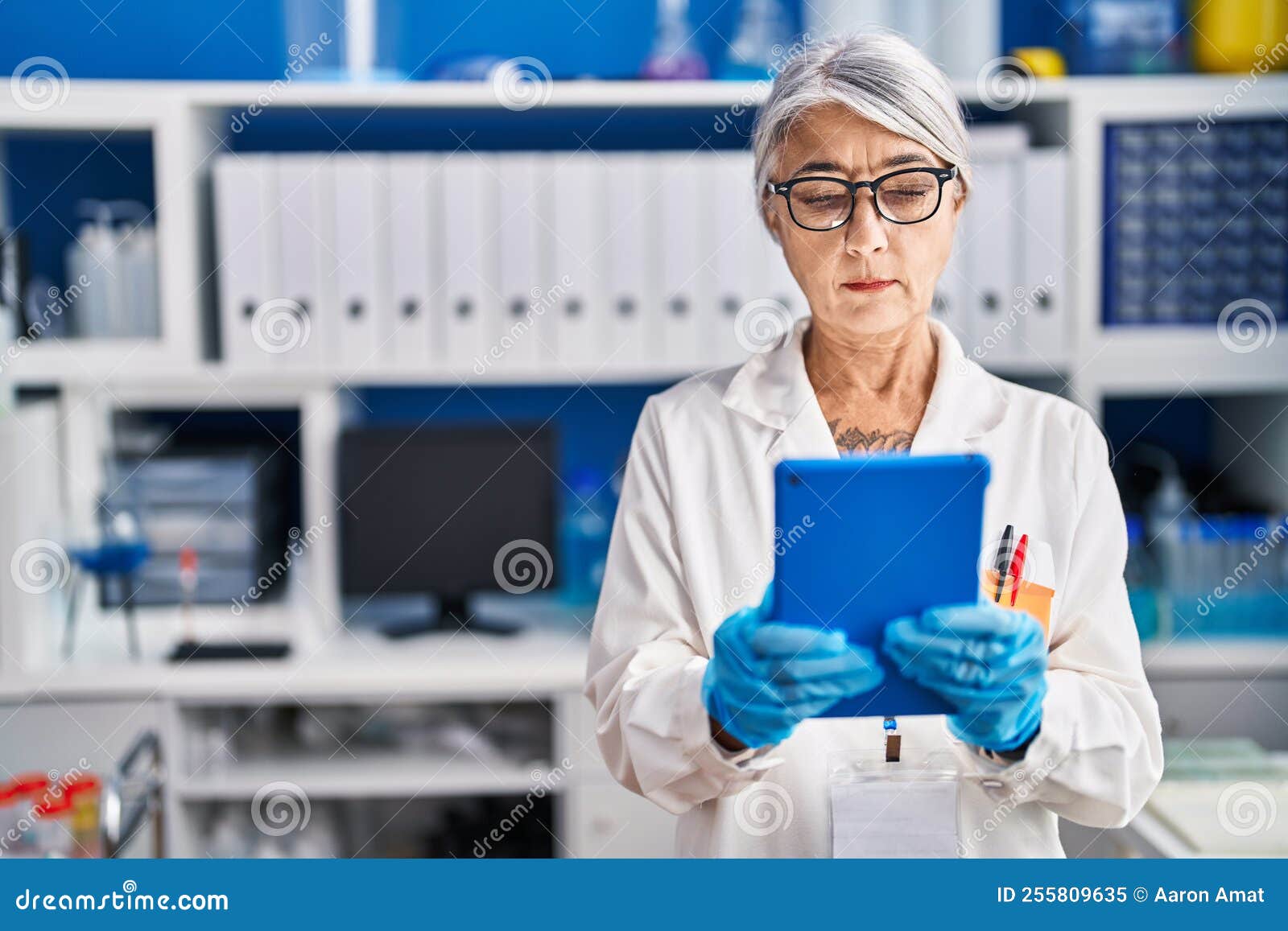 Middle Age Grey-haired Woman Scientist Using Touchpad Working at ...