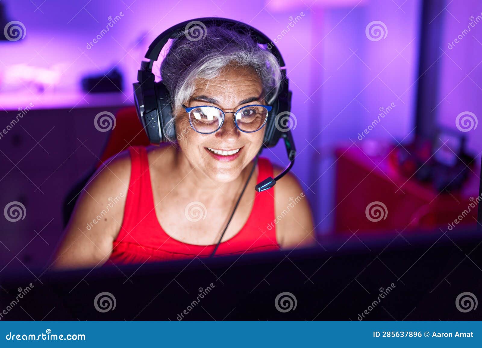 Middle Age Grey-haired Woman Streamer Playing Video Game Using Computer ...