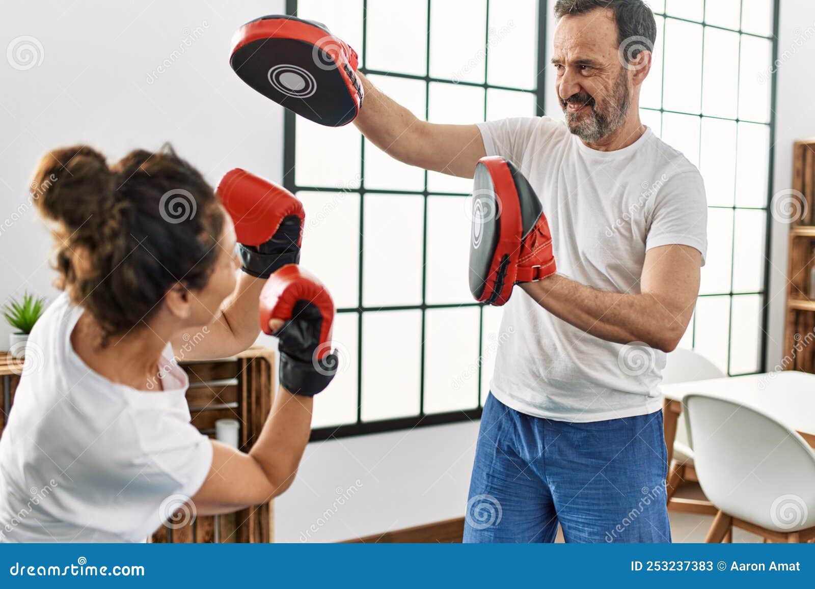 Middle Age Hispanic Couple Smiling Happy Training Boxing at Home Stock ...