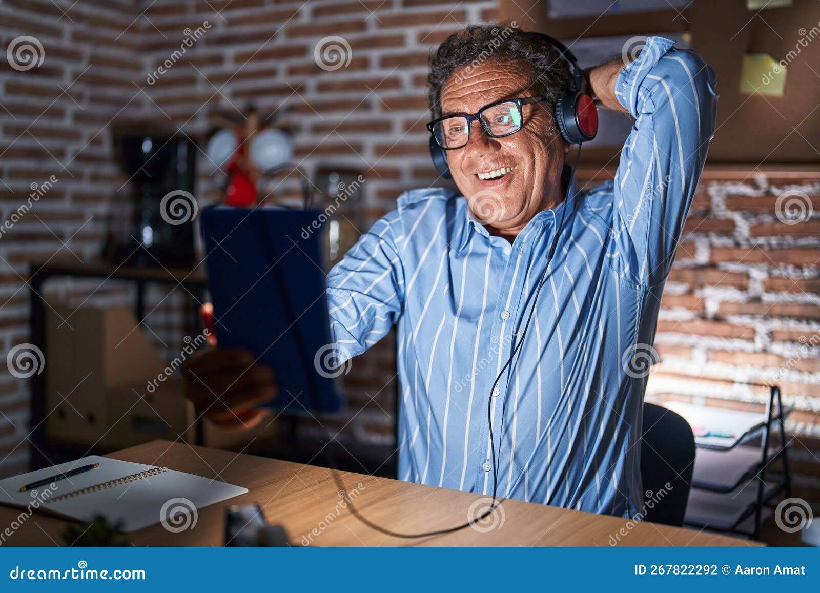 Middle Age Hispanic Man Using Touchpad Sitting on the Table at Night ...