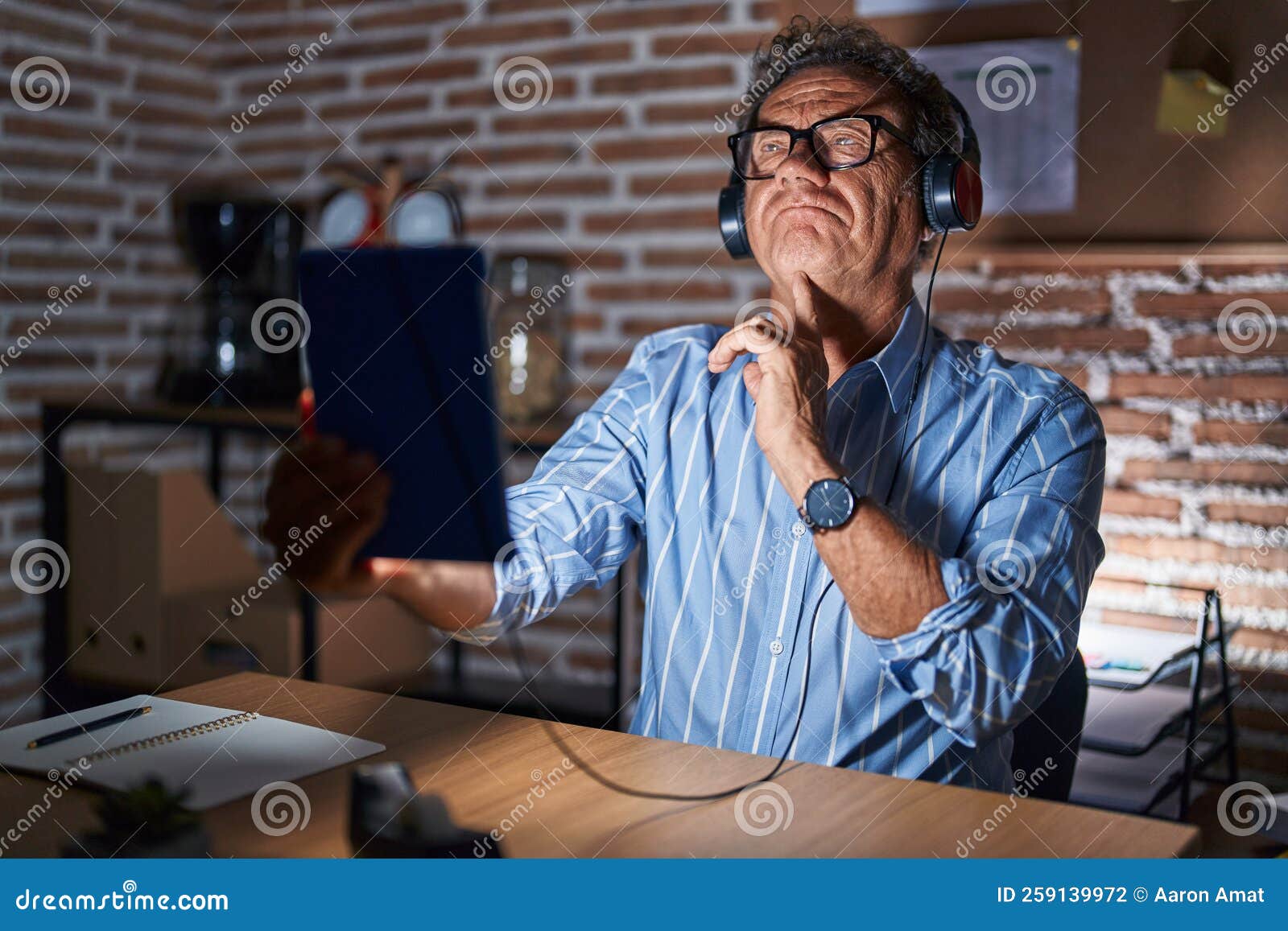 Middle Age Hispanic Man Using Touchpad Sitting on the Table at Night ...