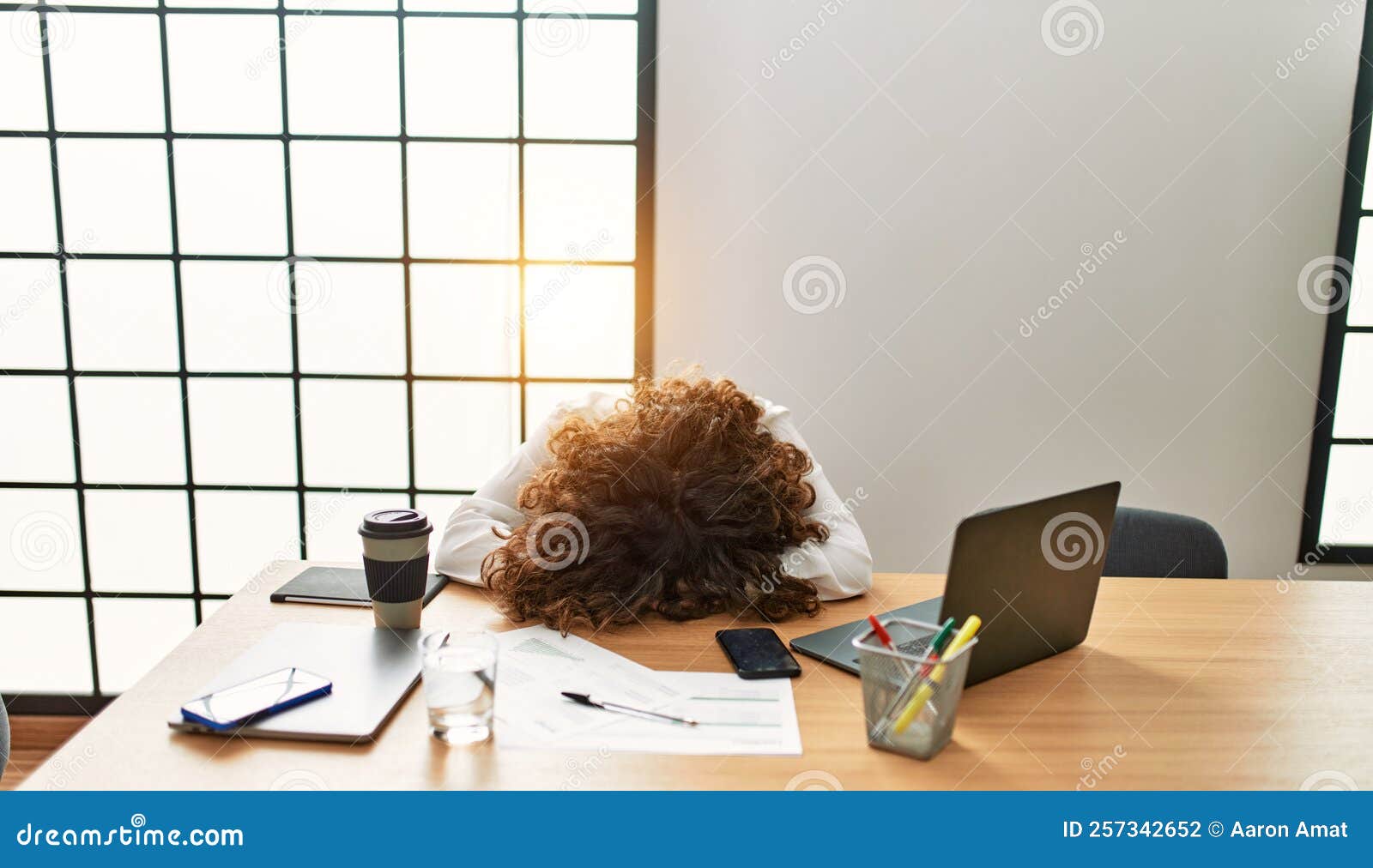 Middle Age Hispanic Woman Overworked with Head on Table at Office Stock ...