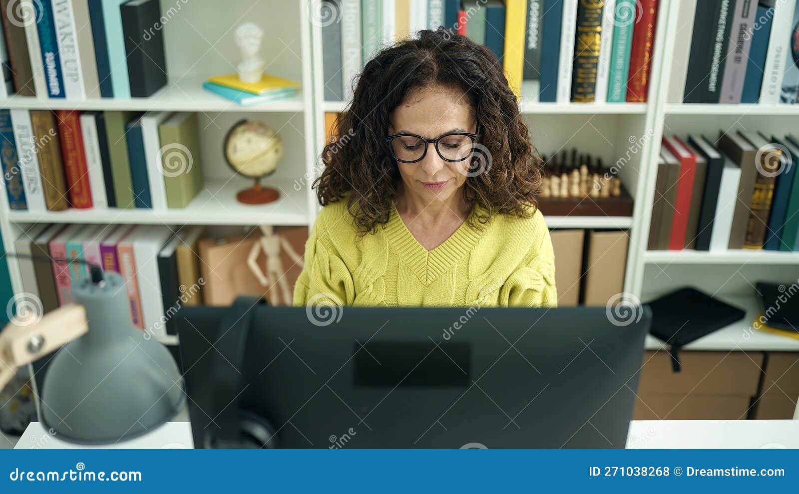 Middle Age Hispanic Woman Teacher Using Computer Studying at Library ...