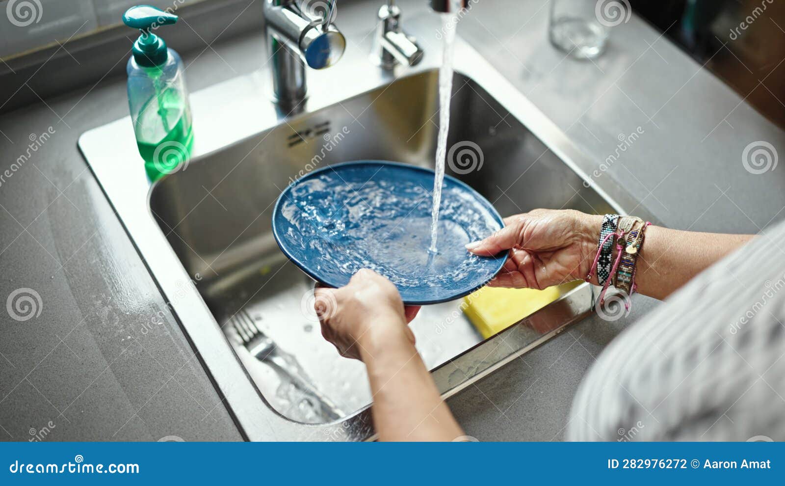 Middle Age Hispanic Woman Washing Plates at the Kitchen Stock Photo ...