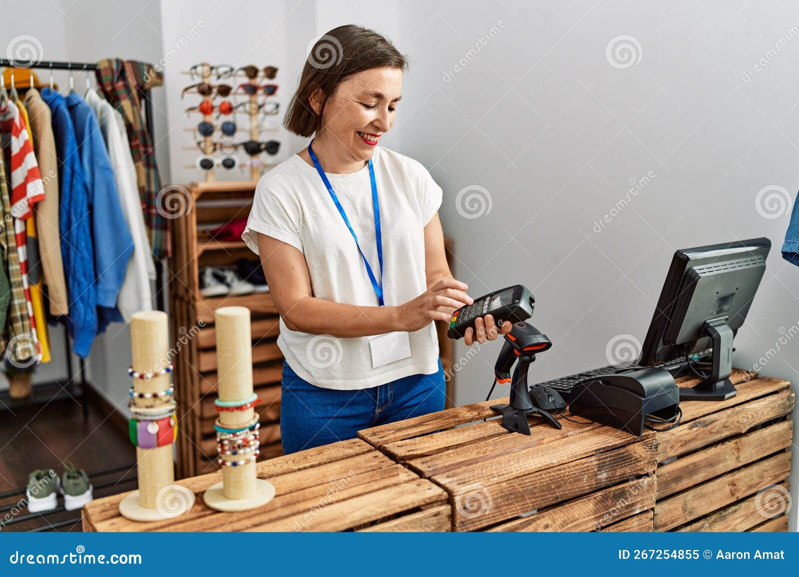 Middle Age Hispanic Woman Working Using Dataphone at Retail Shop Stock ...