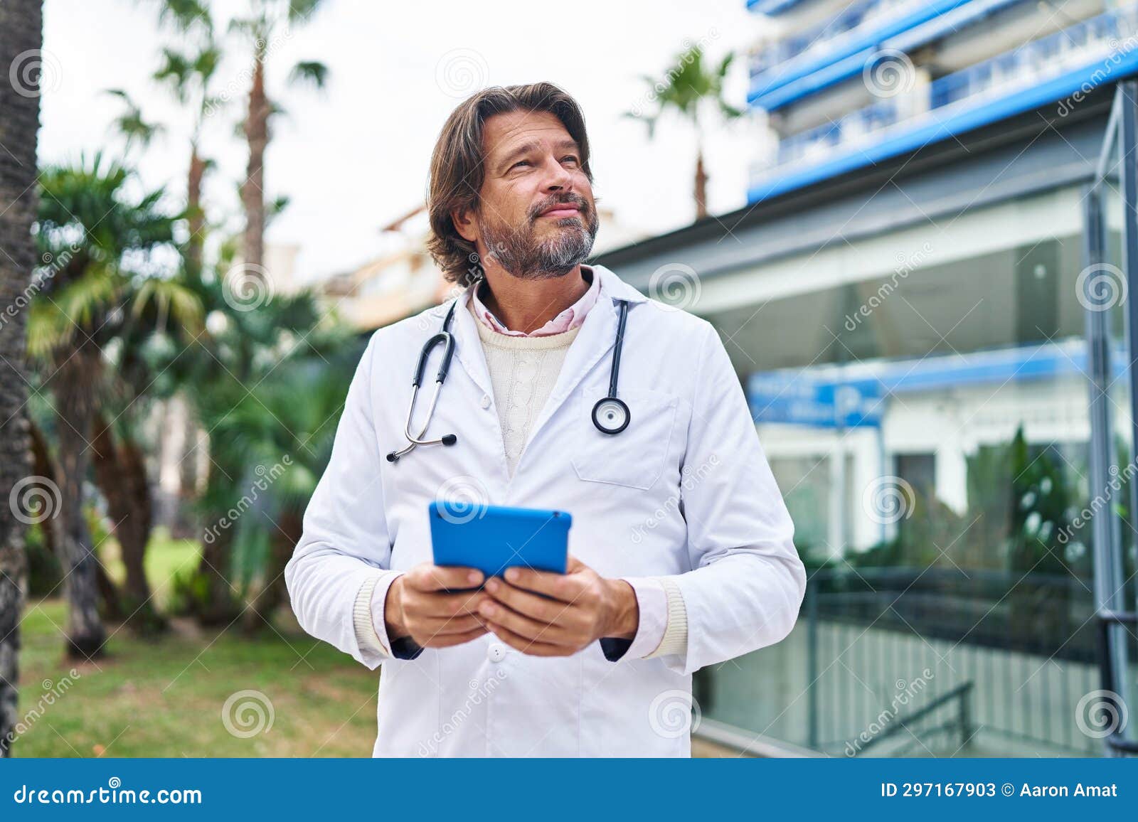Middle Age Man Doctor Smiling Confident Using Touchpad at Hospital ...