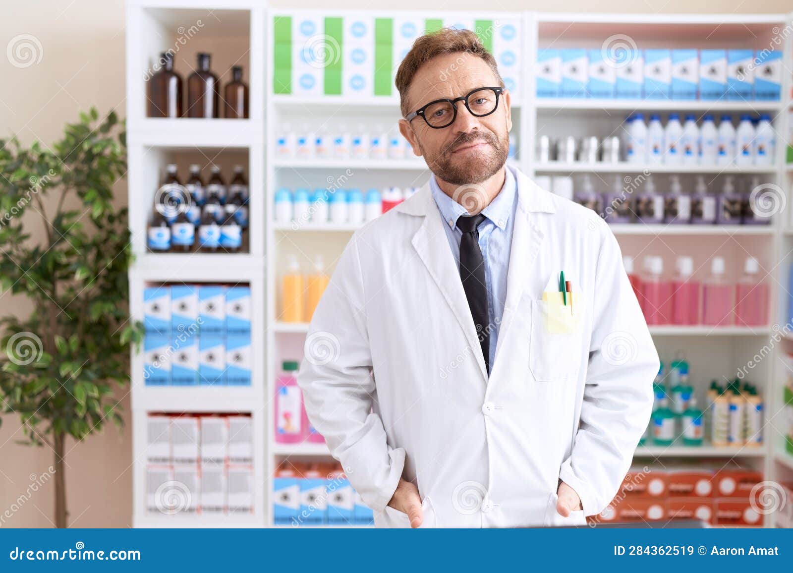 Middle Age Man Pharmacist Smiling Confident Standing at Pharmacy Stock ...