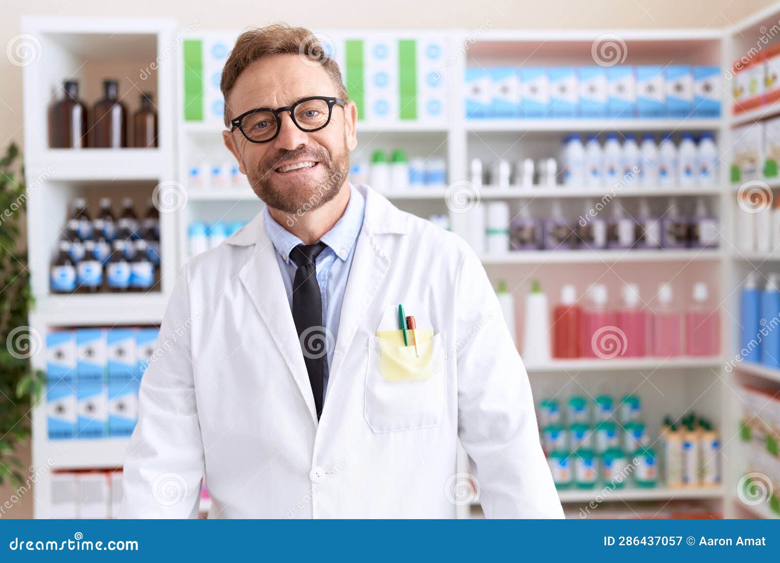 Middle Age Man Pharmacist Smiling Confident Standing at Pharmacy Stock ...