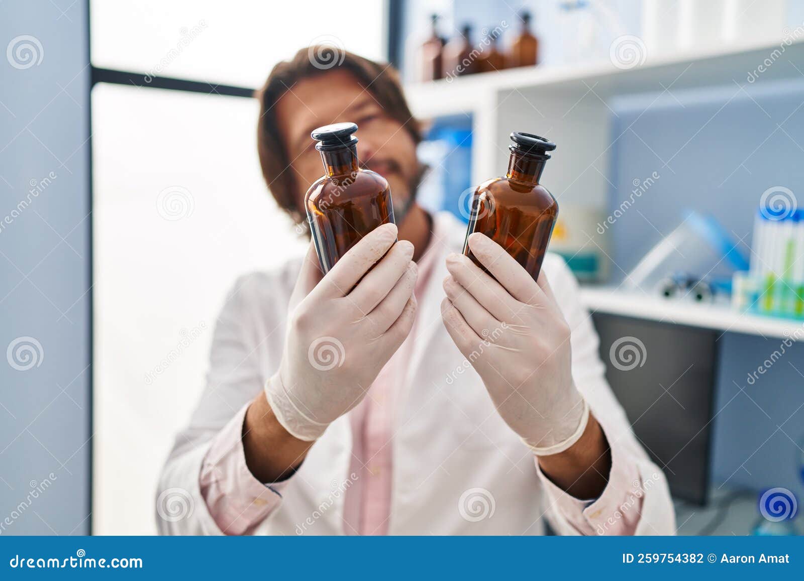 Middle Age Man Scientist Holding Bottles at Laboratory Stock Photo ...