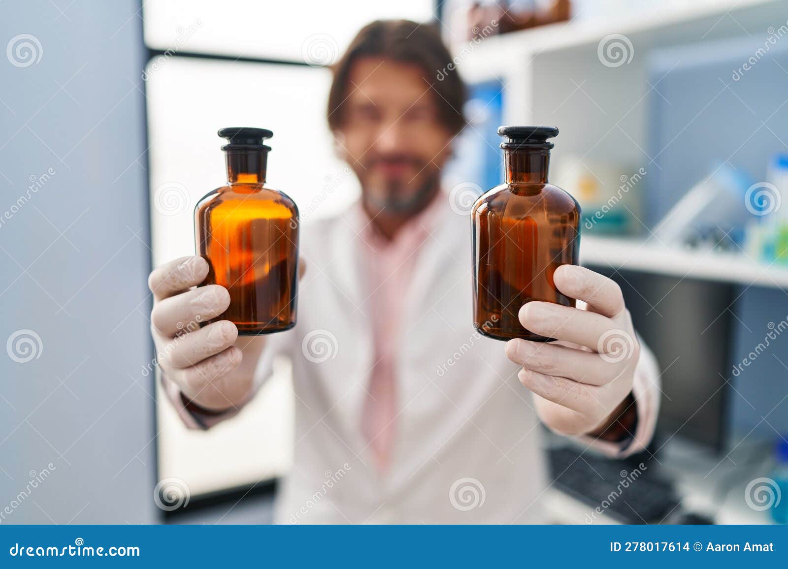 Middle Age Man Scientist Holding Bottles at Laboratory Stock Photo ...