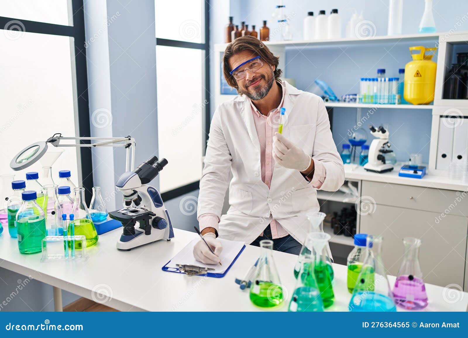 Middle Age Man Scientist Holding Test Tube Writing on Document at ...