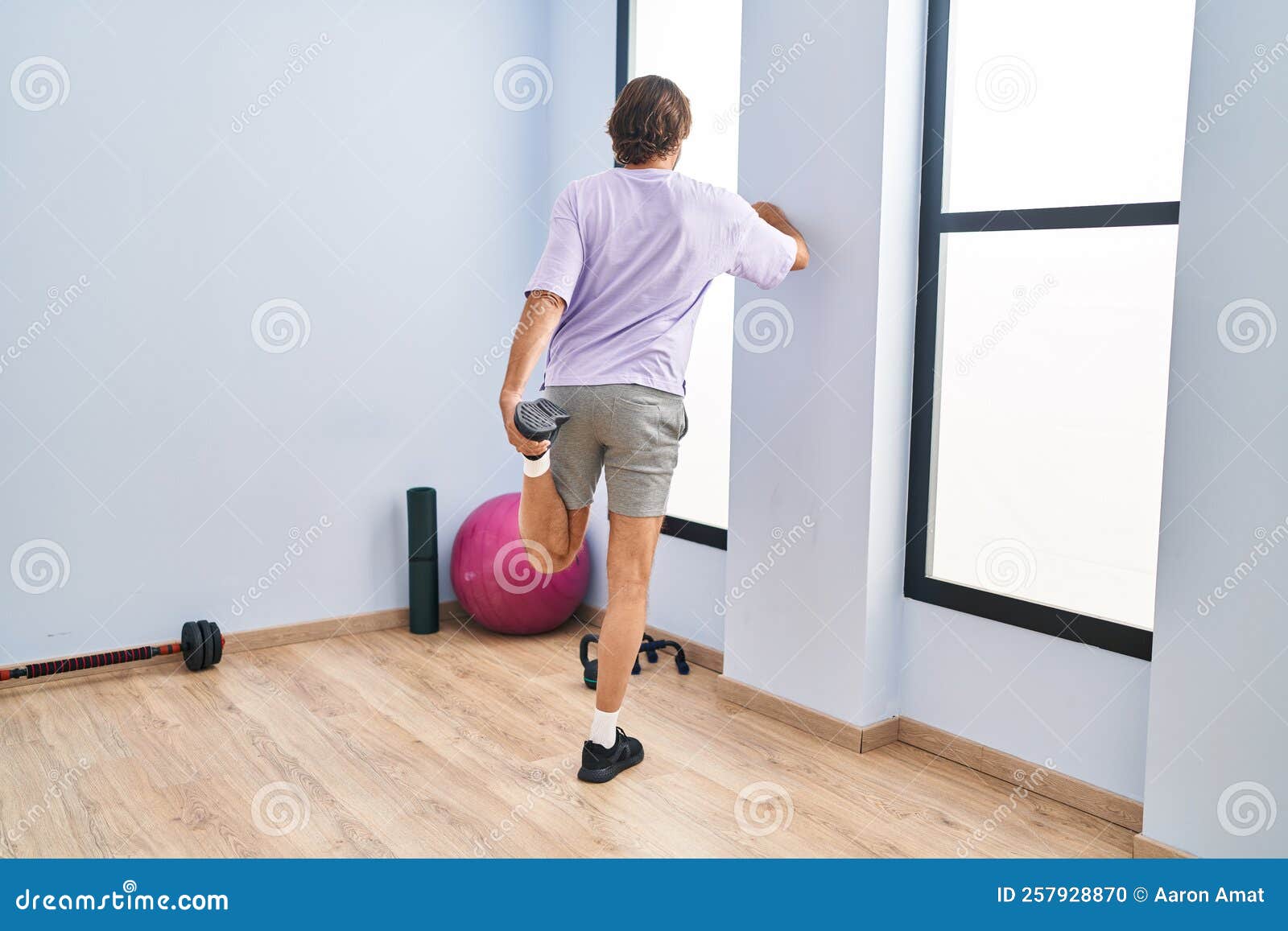 Middle Age Man Stretching Leg on Back View at Sport Center Stock Photo ...