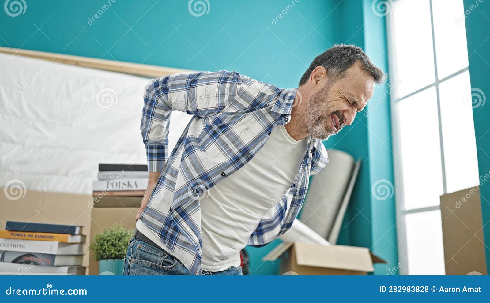Middle Age Man Suffering for Backache at New Home Stock Photo - Image ...