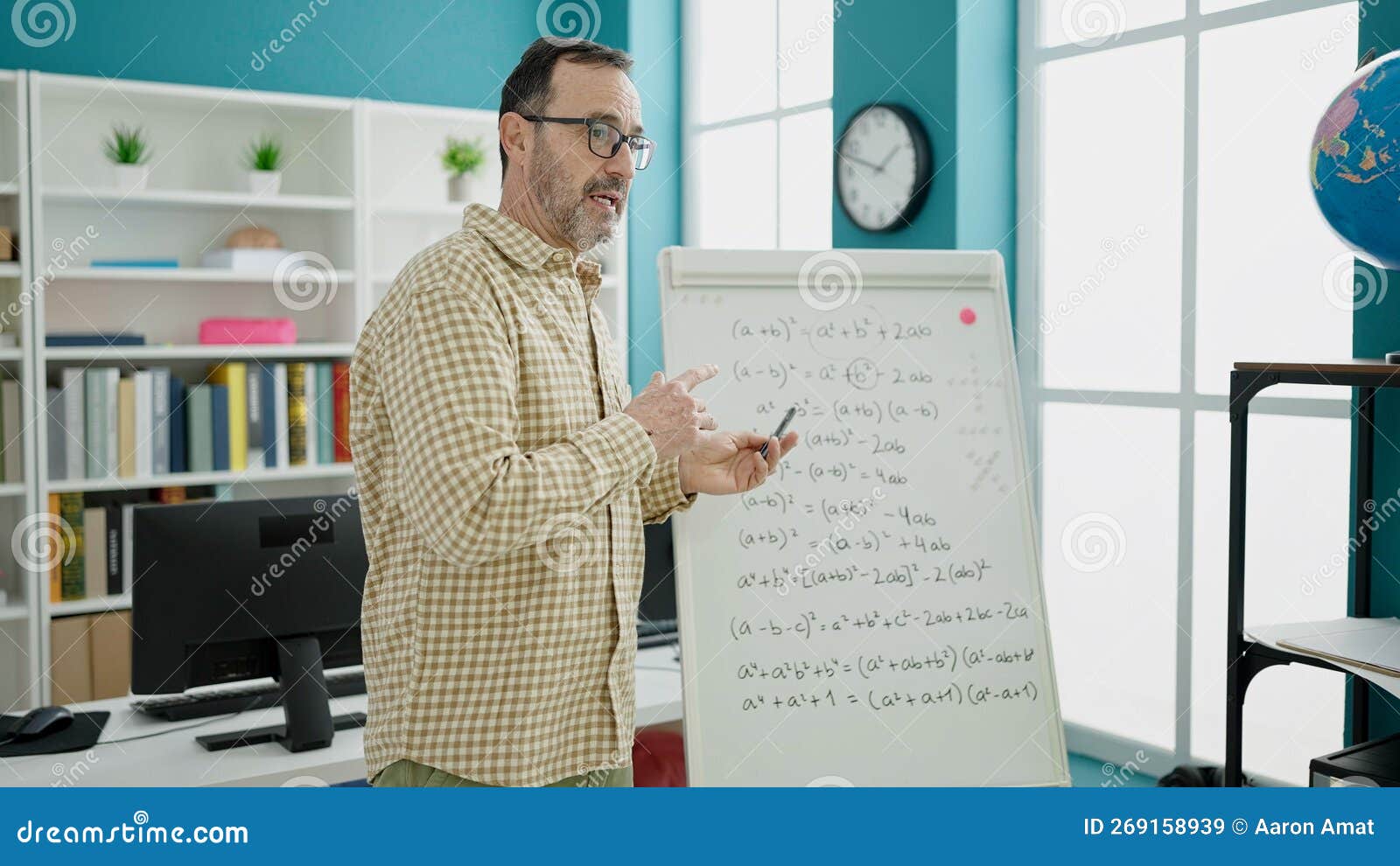 Middle Age Man Teacher Teaching Maths Lesson at Classroom Stock Image ...