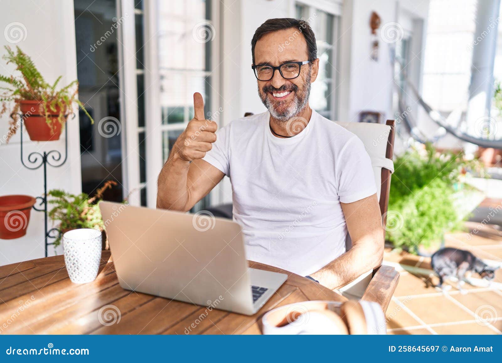 Middle Age Man Using Computer Laptop at Home Doing Happy Thumbs Up ...