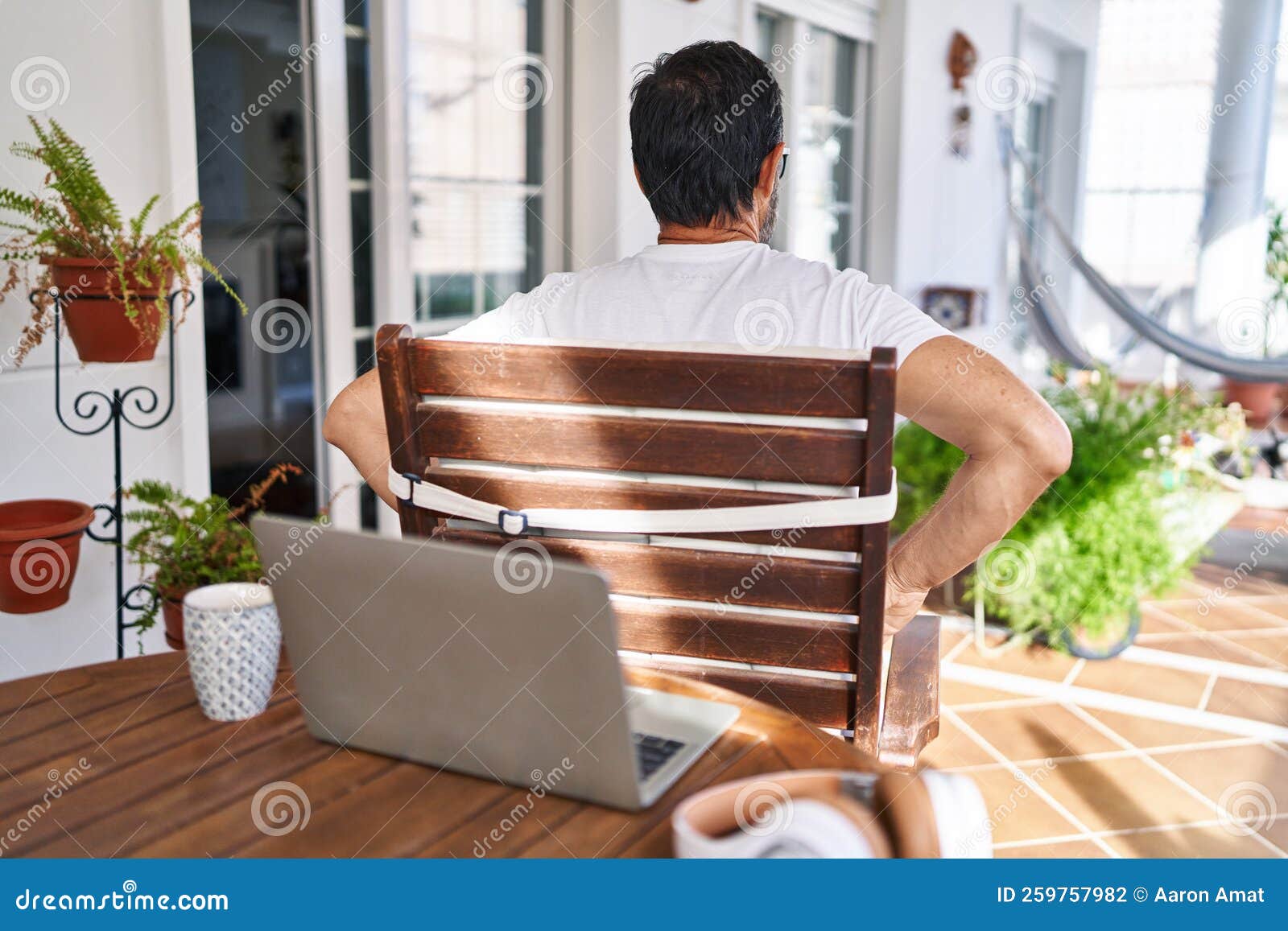 Middle Age Man Using Computer Laptop at Home Standing Backwards Looking ...