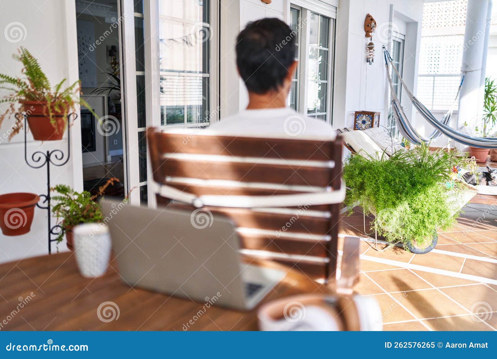 Middle Age Man Using Computer Laptop at Home Standing Backwards Looking ...