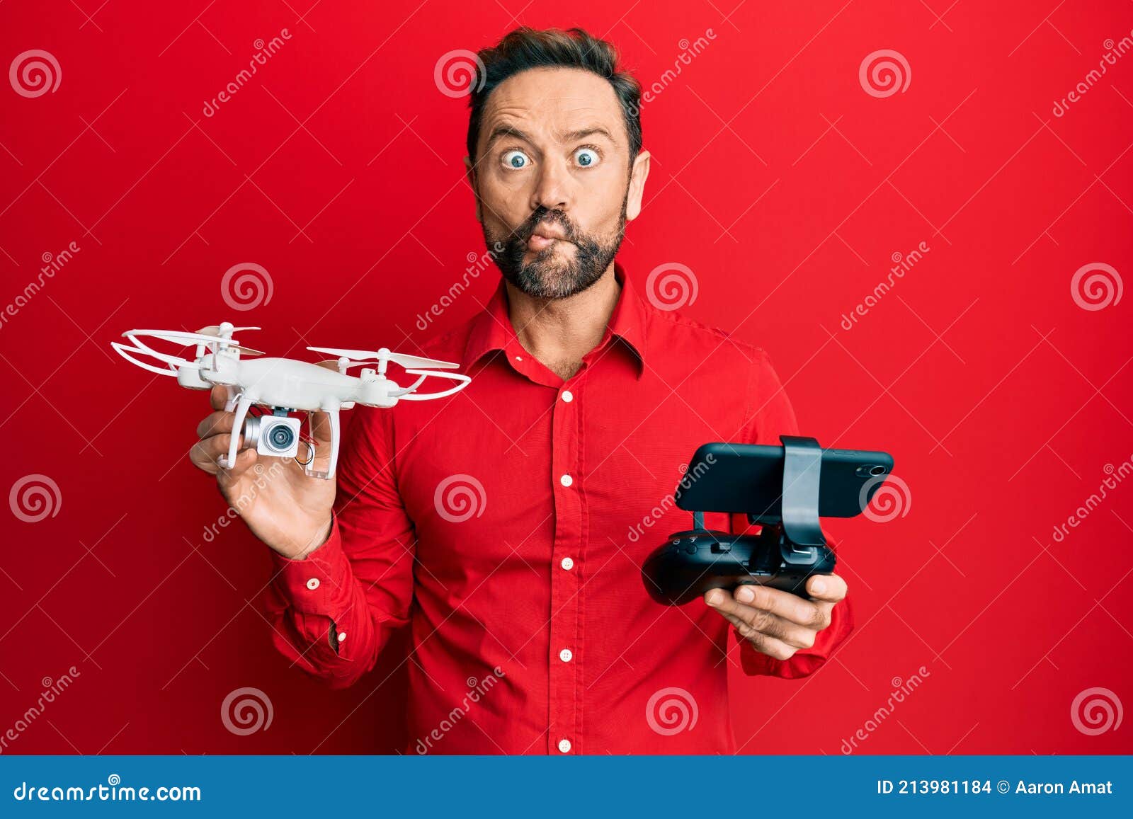 Middle Age Man Using Drone Making Fish Face with Mouth and Squinting ...