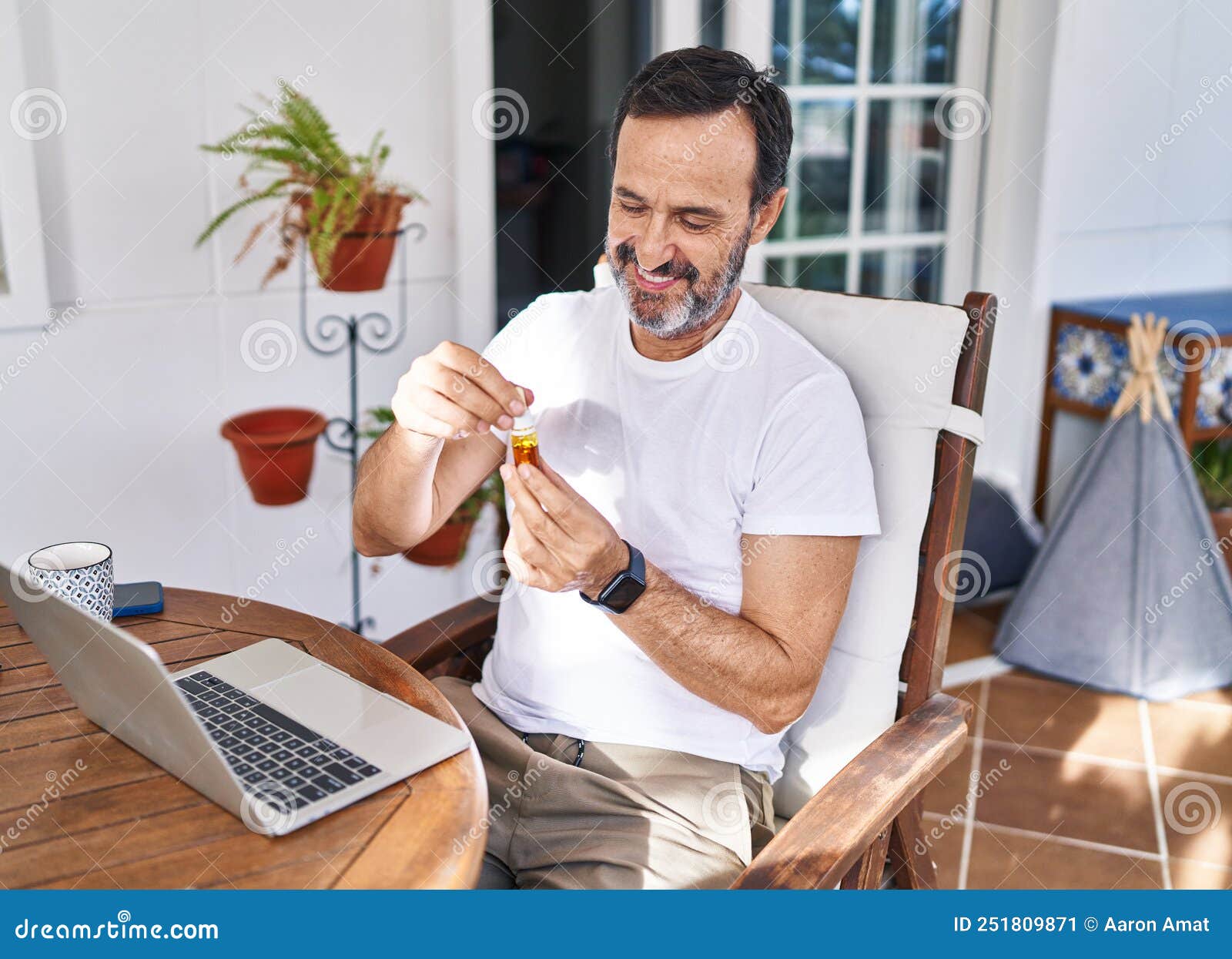 Middle Age Man Using Laptop Drinking Medicine Syrup at Terrace Home ...