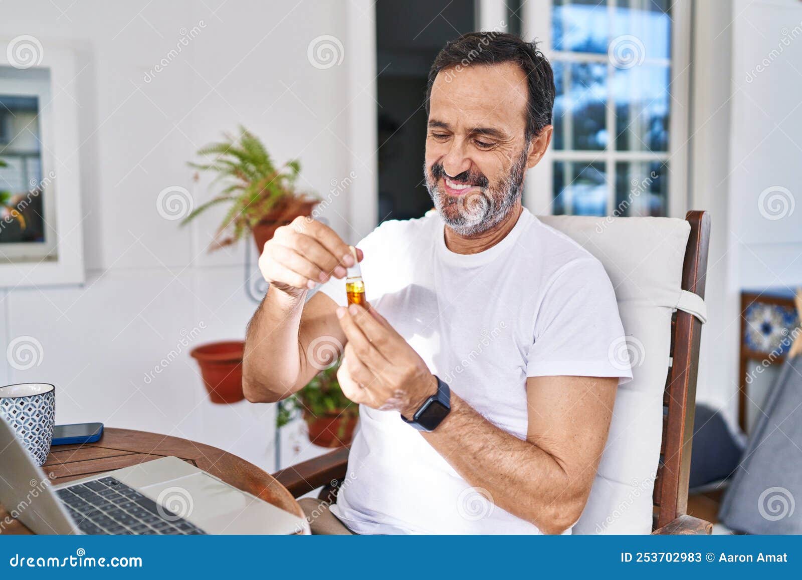 Middle Age Man Using Laptop Drinking Medicine Syrup at Terrace Home ...