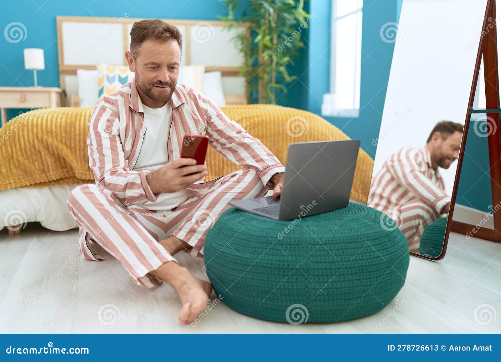 Middle Age Man Using Smartphone and Laptop Sitting on Floor at Bedroom ...