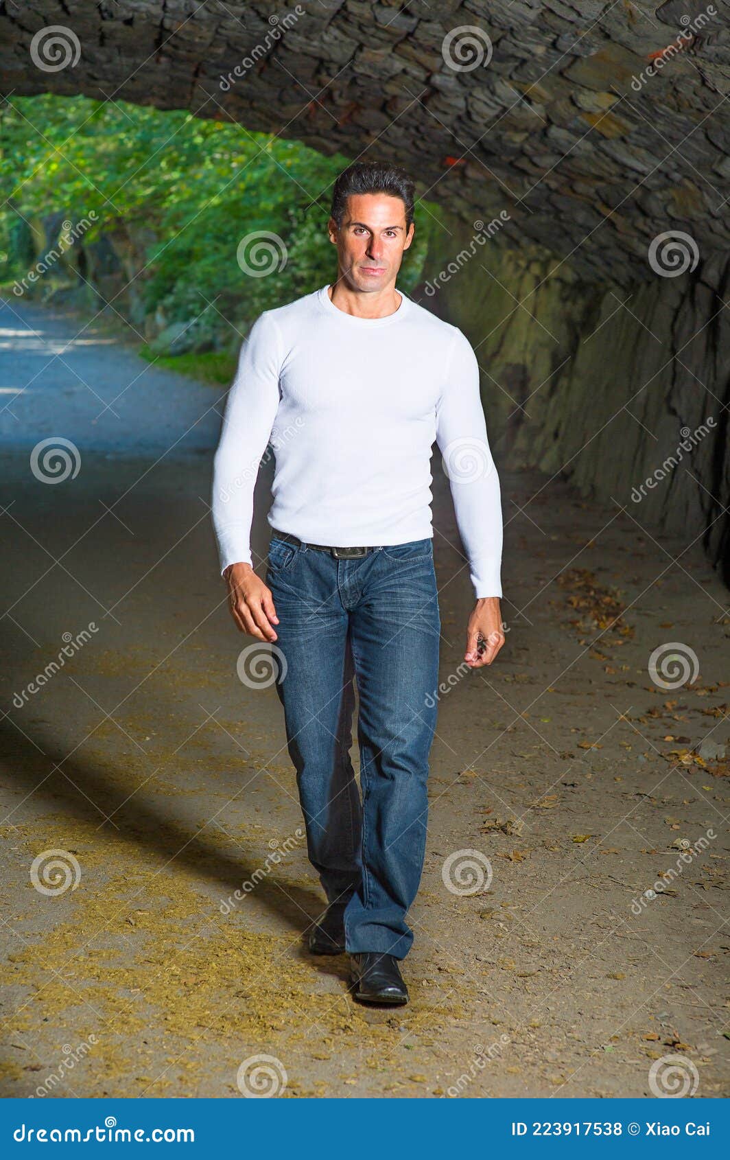 Middle Age Man Walking through an Arch in the Morning Stock Photo ...