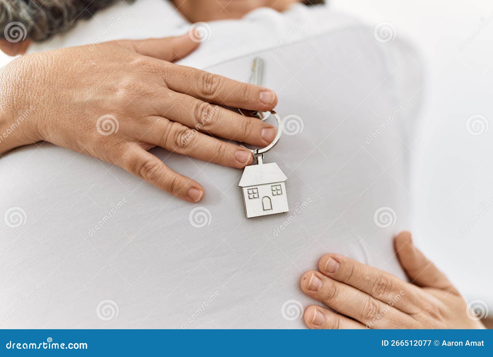 Middle Age Man And Woman Couple Hugging Each Other Holding Key Of New