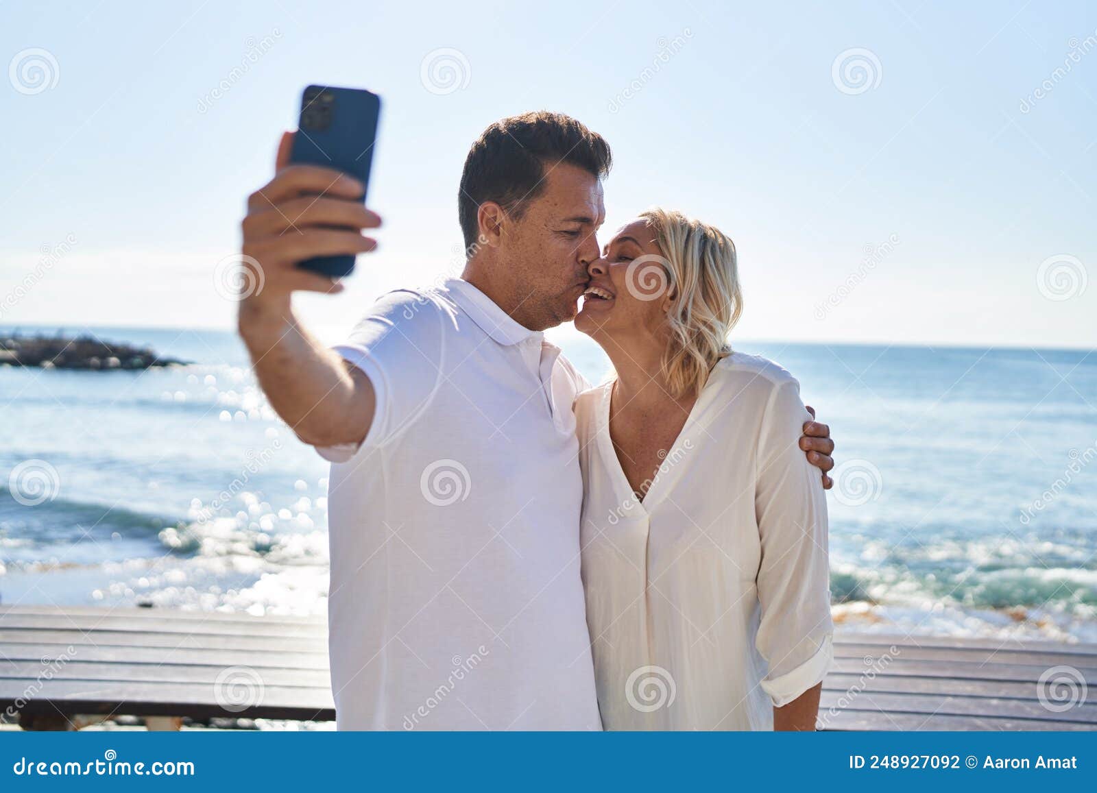 Middle Age Man And Woman Couple Hugging Each Other And Kissing Make