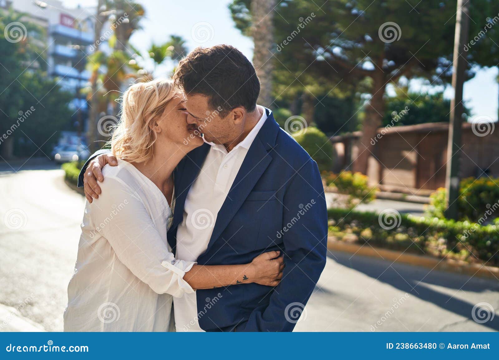 Middle Age Man And Woman Couple Hugging Each Other And Kissing Standing