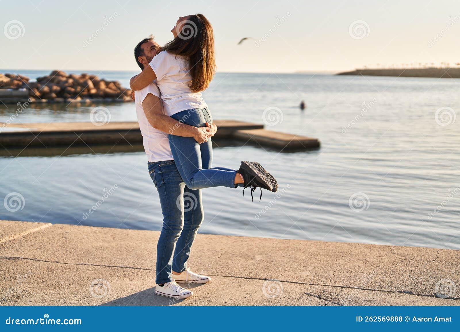 Middle Age Man And Woman Couple Hugging Each Other Standing At Seaside