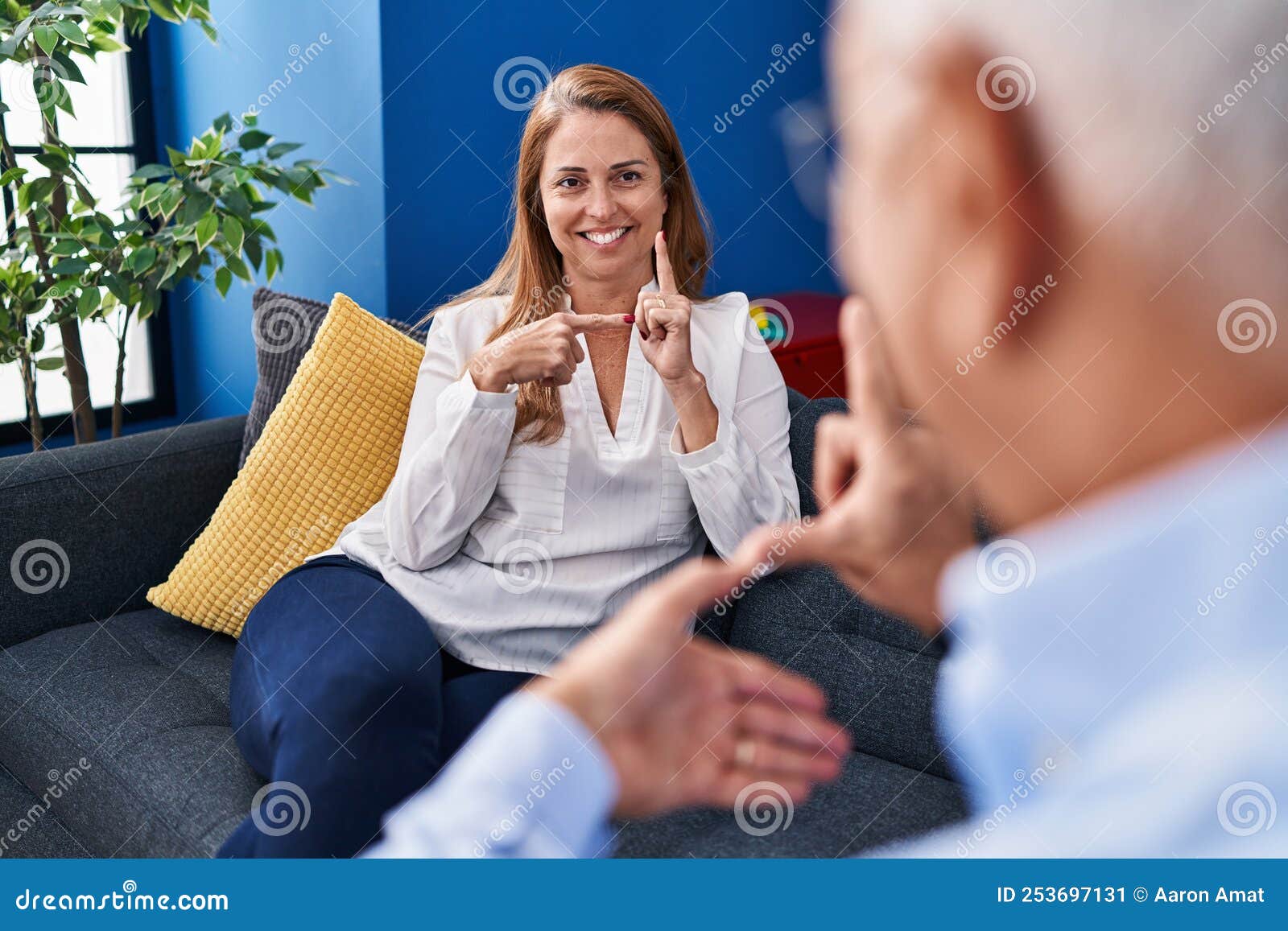 Middle Age Man and Woman Couple Using Deaf Sign Language at Home Stock ...