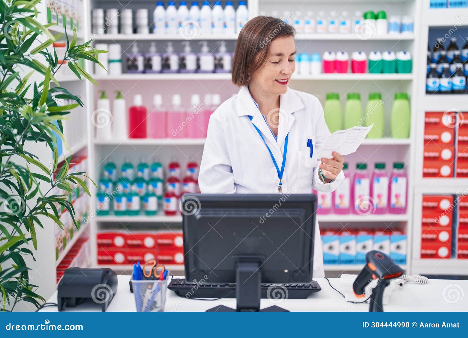 Middle Age Woman Pharmacist Using Computer Reading Prescription at ...