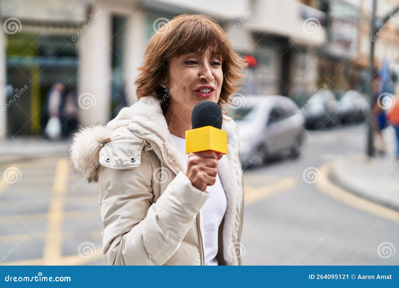 Middle Age Woman Reporter Working Using Microphone at Street Stock ...