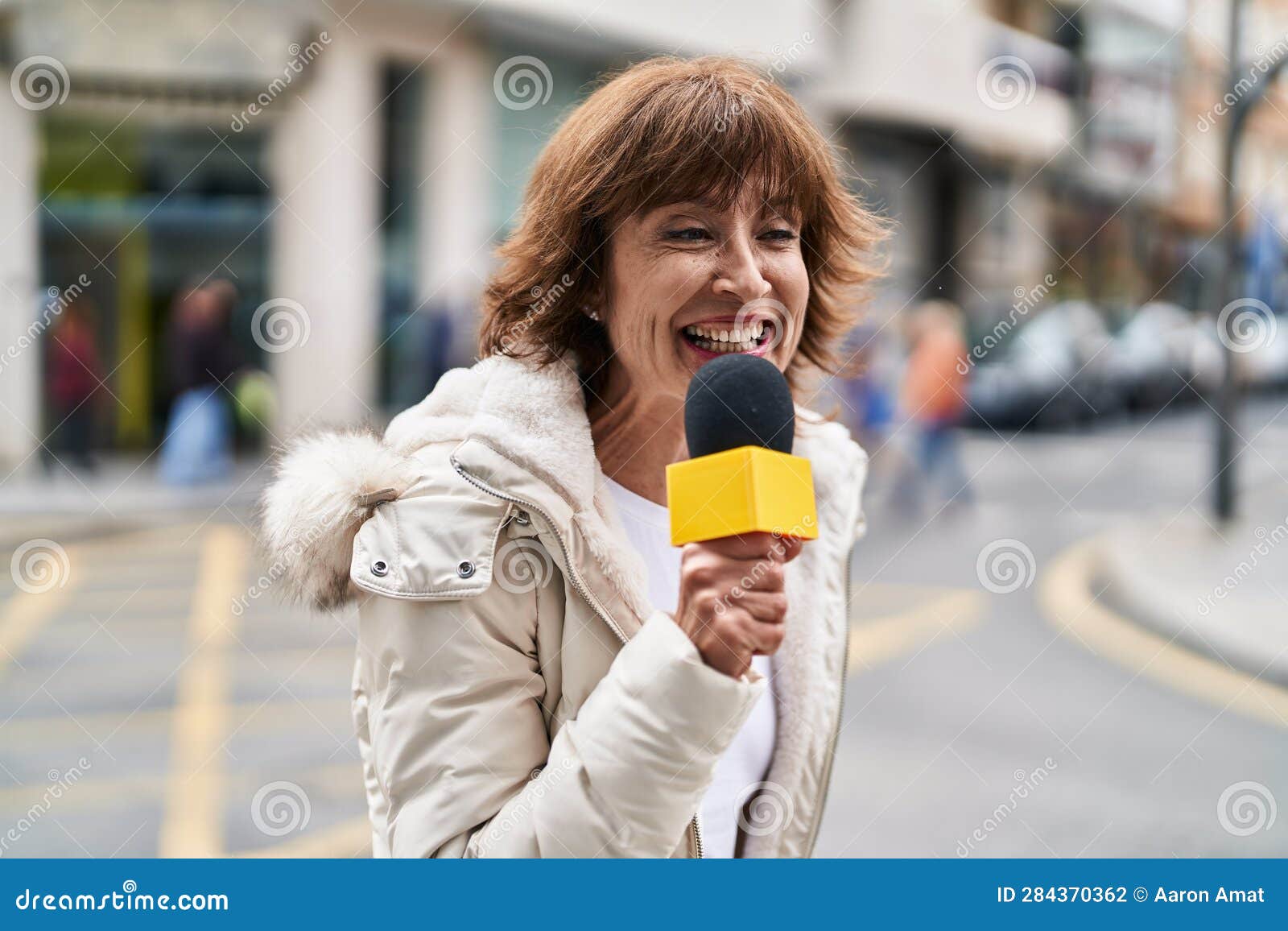 Middle Age Woman Reporter Working Using Microphone at Street Stock ...