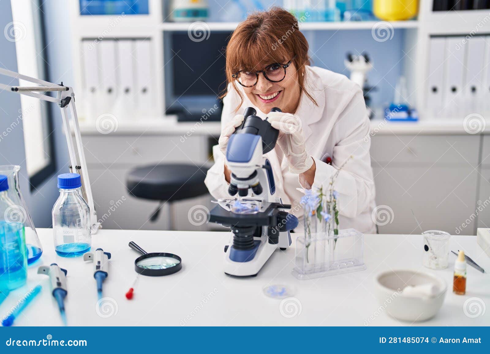 Middle Age Woman Scientist Smiling Confident Using Microscope at ...