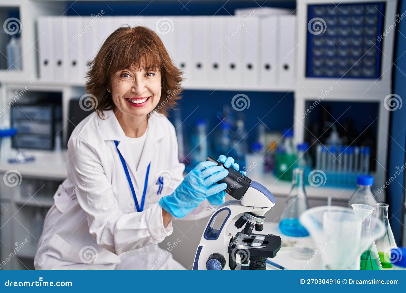 Middle Age Woman Scientist Using Microscope at Laboratory Stock Photo ...