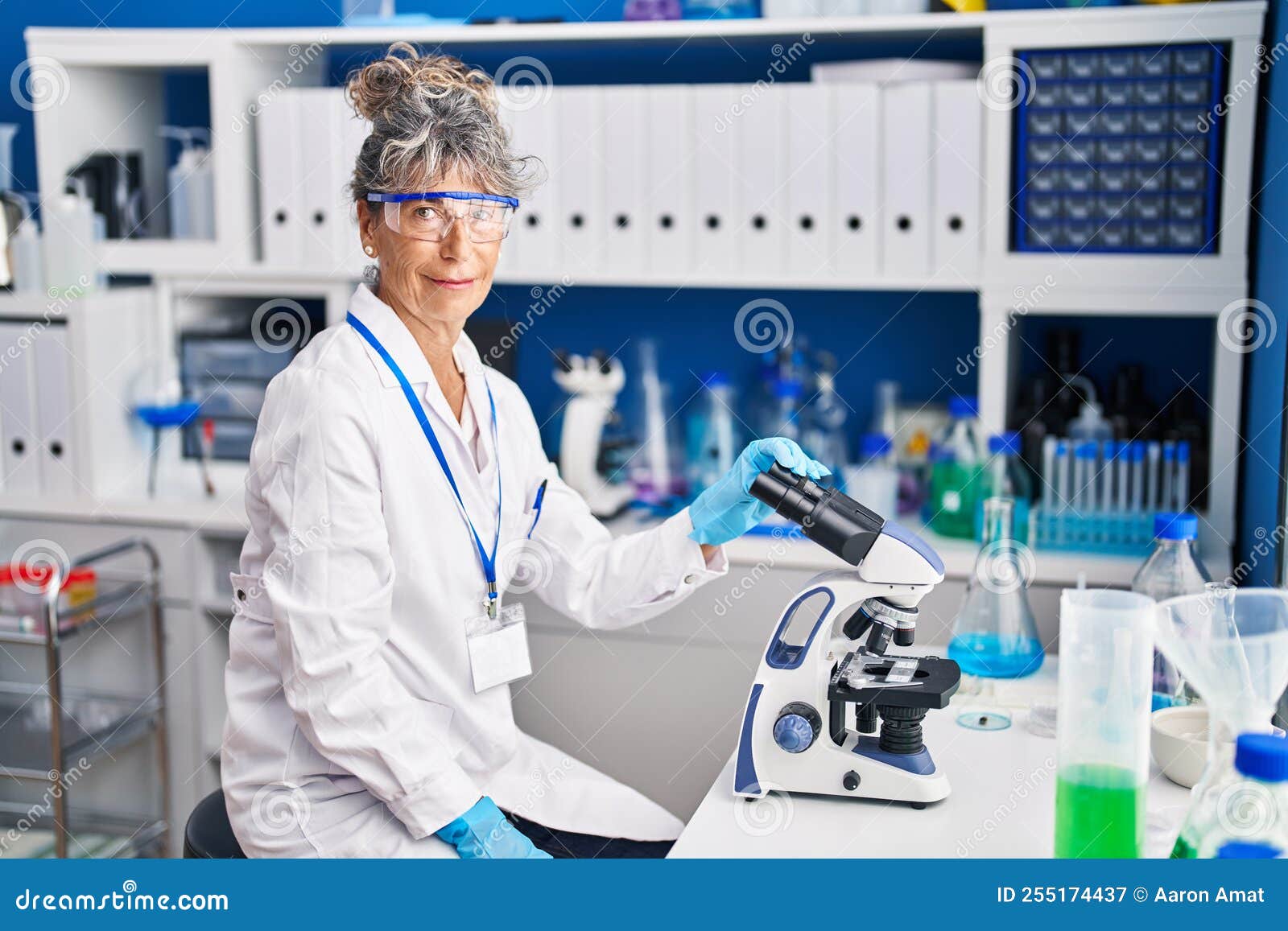 Middle Age Woman Scientist Using Microscope Working at Laboratory Stock ...