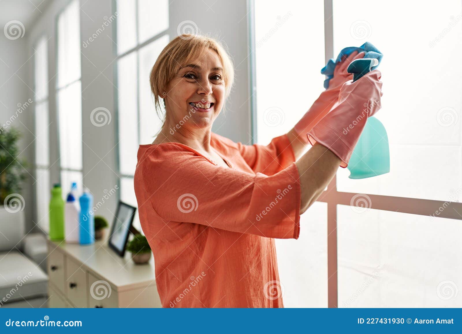 Middle Age Woman Smiling Happy Cleaning Using Diffuser and Rag at Home ...