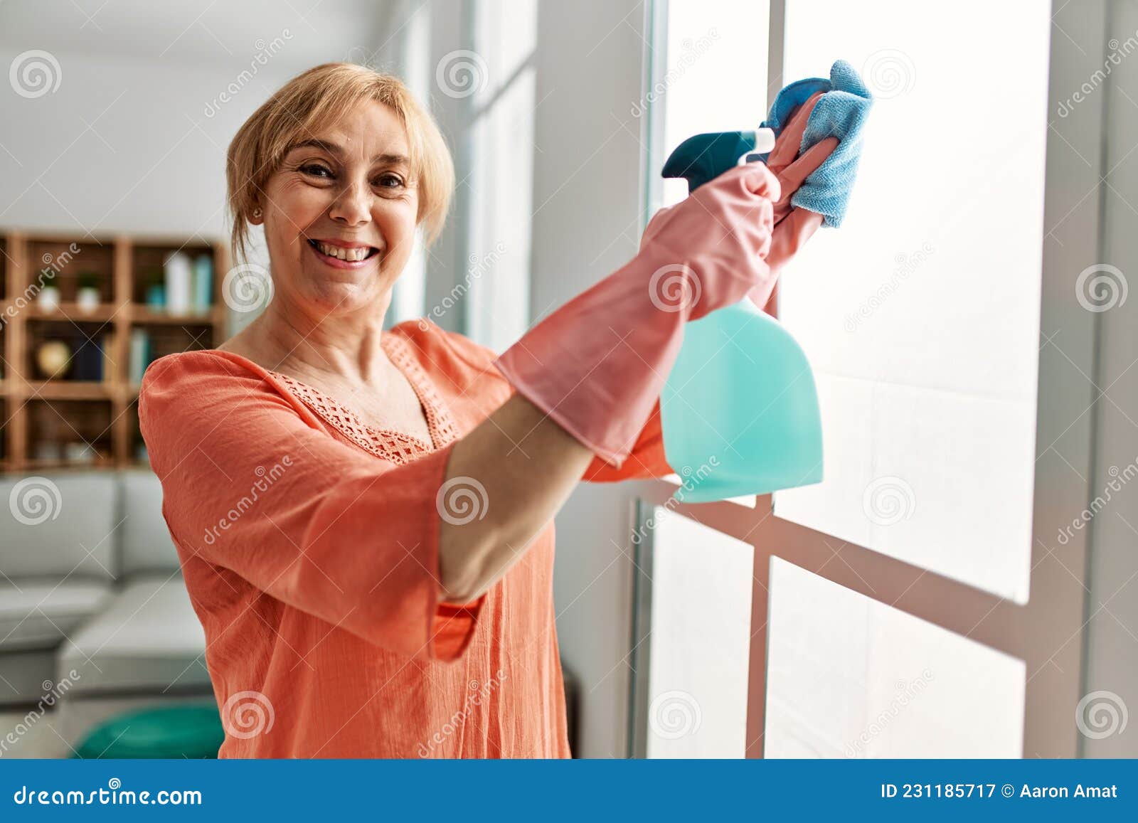 Middle Age Woman Smiling Happy Cleaning Using Diffuser and Rag at Home ...