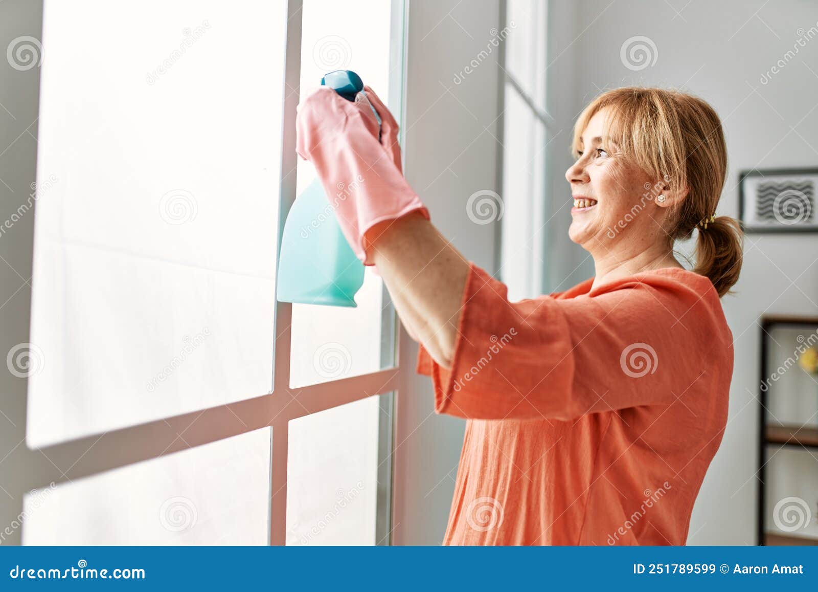 Middle Age Woman Smiling Happy Cleaning Using Diffuser and Rag at Home ...