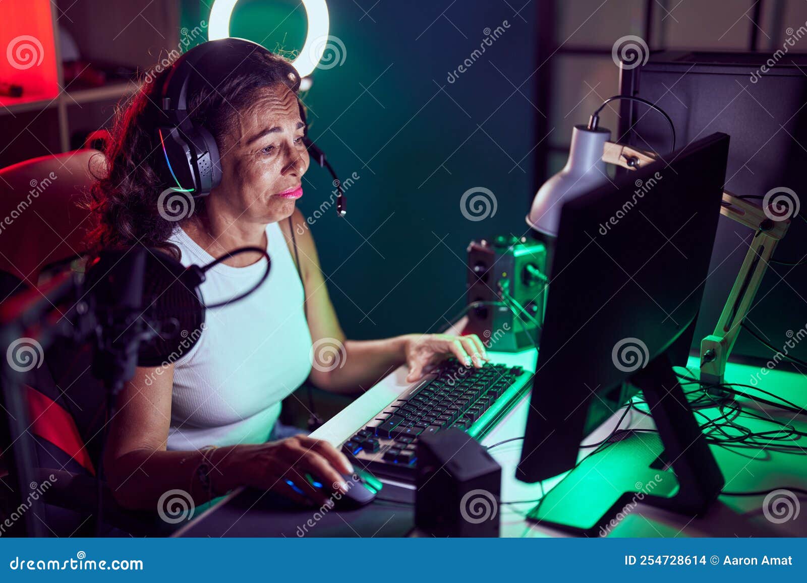 Middle Age Woman Streamer Playing Video Game Using Computer at Gaming ...