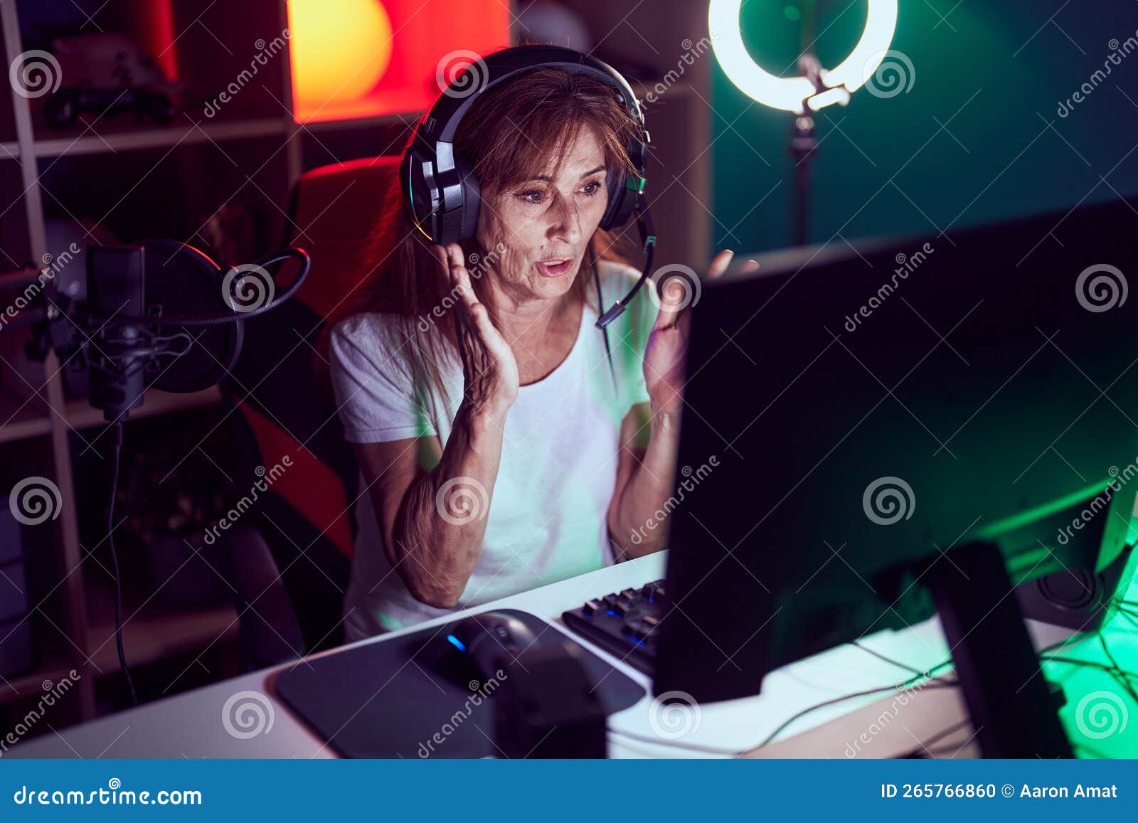 Middle Age Woman Streamer Playing Video Game Using Computer at Gaming ...