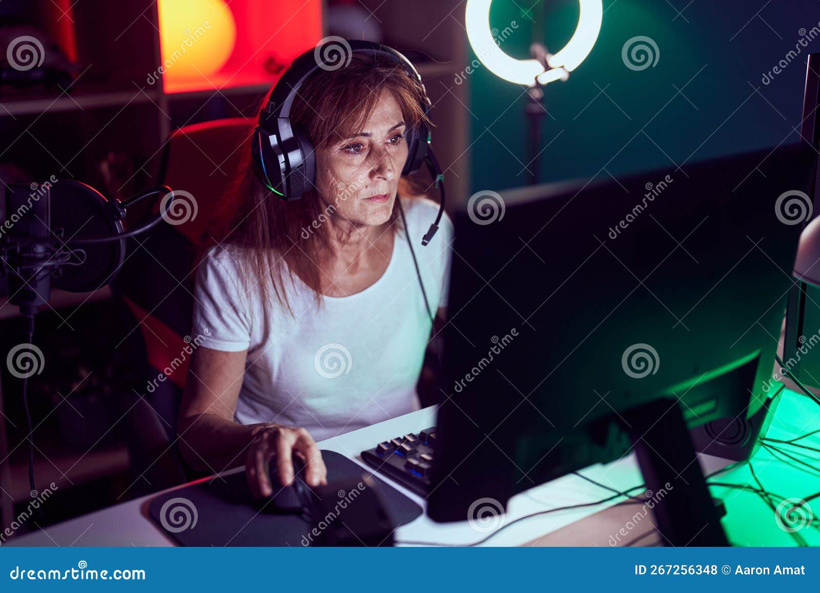 Middle Age Woman Streamer Playing Video Game Using Computer at Gaming ...
