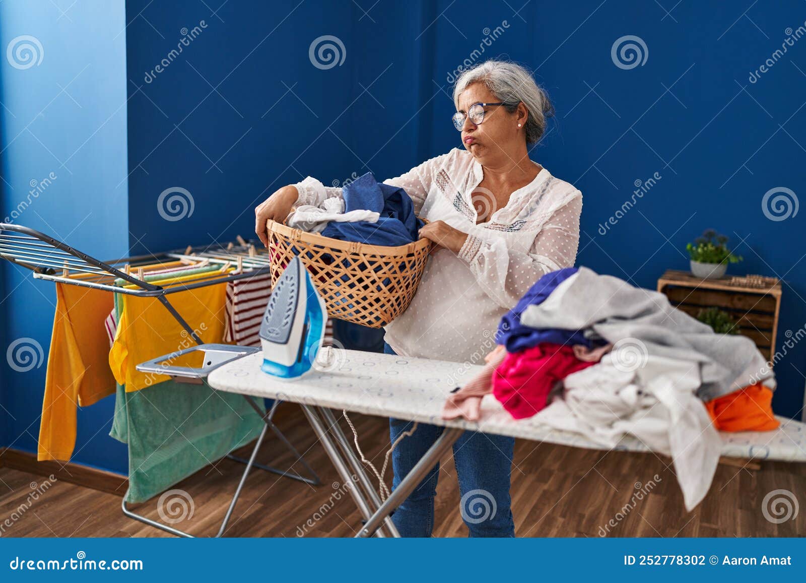Middle Age Woman Stressed Doing Chores at Laundry Room Stock Photo ...