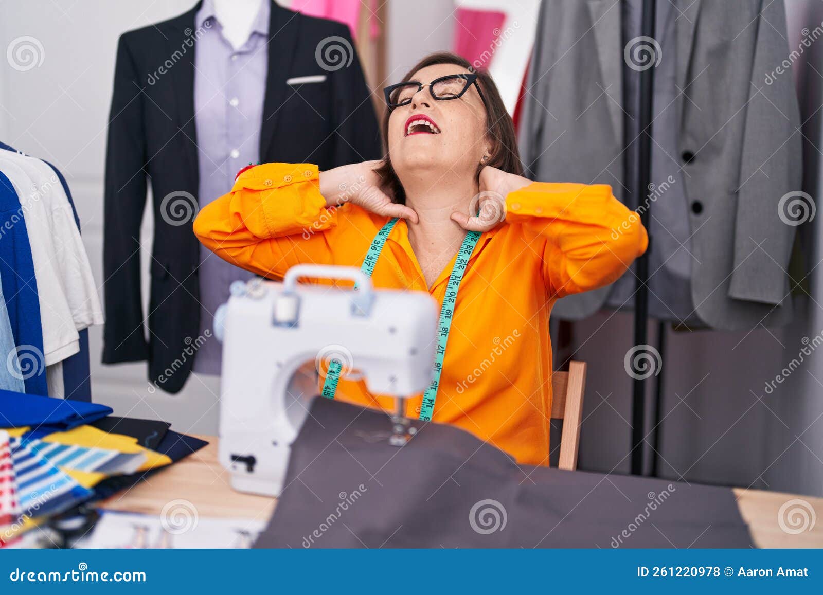 Middle Age Woman Tailor Stressed Using Sewing Machine at Tailor Shop ...