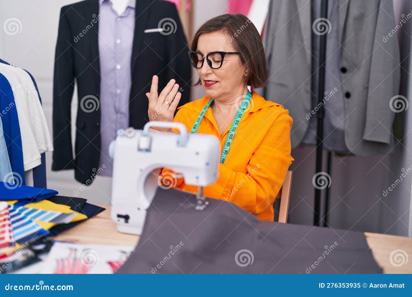 Middle Age Woman Tailor Stressed Using Sewing Machine at Tailor Shop ...