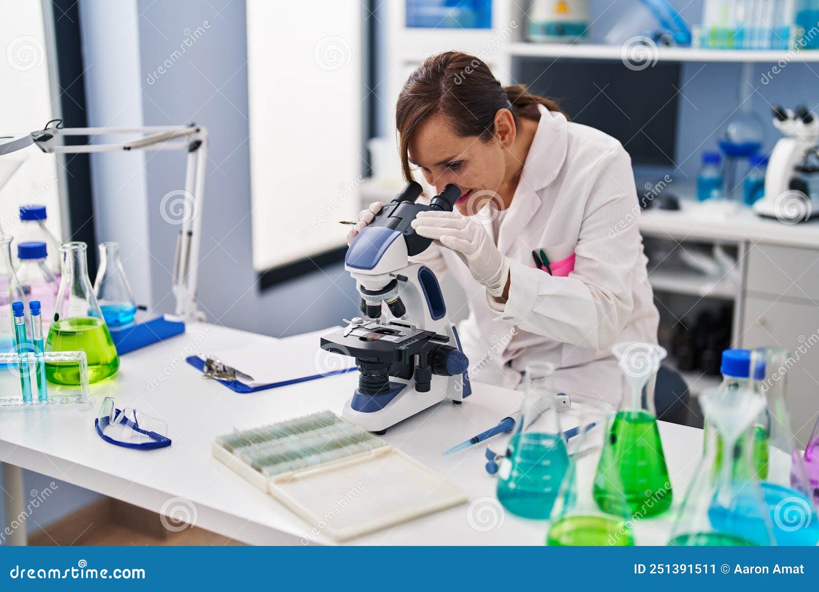 Middle Age Woman Wearing Scientist Uniform Using Microscope at ...